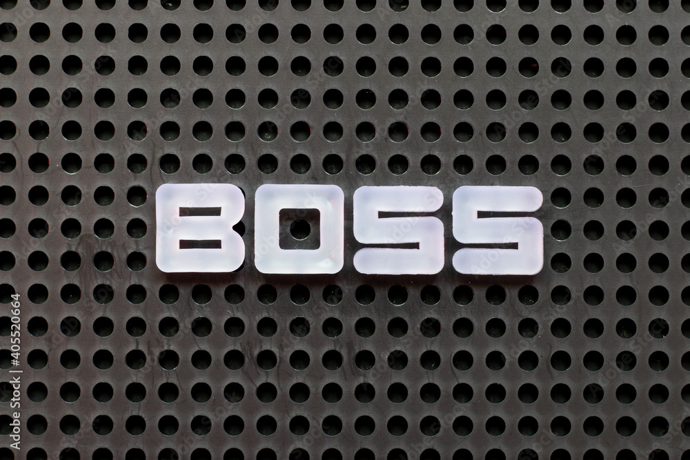 White color letter in word boss on black pegboard background Stock ...