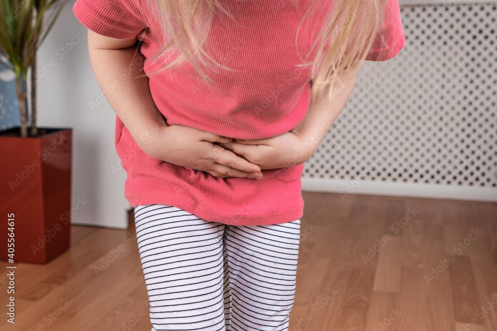child keeps hands on belly at home. abdominal pain in a child ...