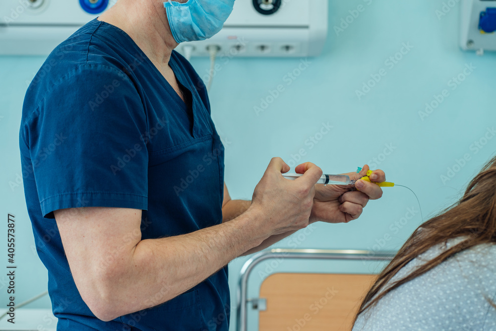Doctor or nurse hand in holding syringe injection for epidural ...