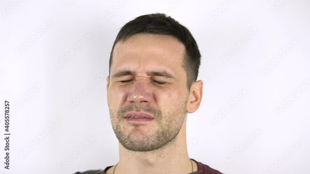 Fresh herring hits the face of a young attractive guy. Funny young guy ...