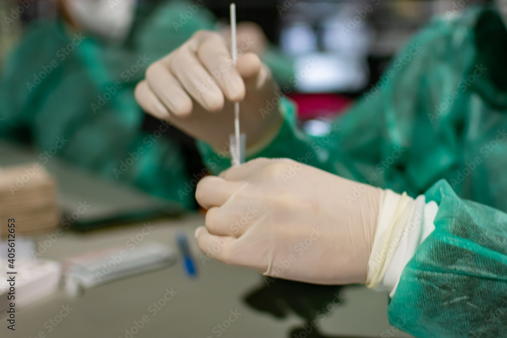 The medical worker conducting a Coronavirus COVID-19 NP OP swab sample ...
