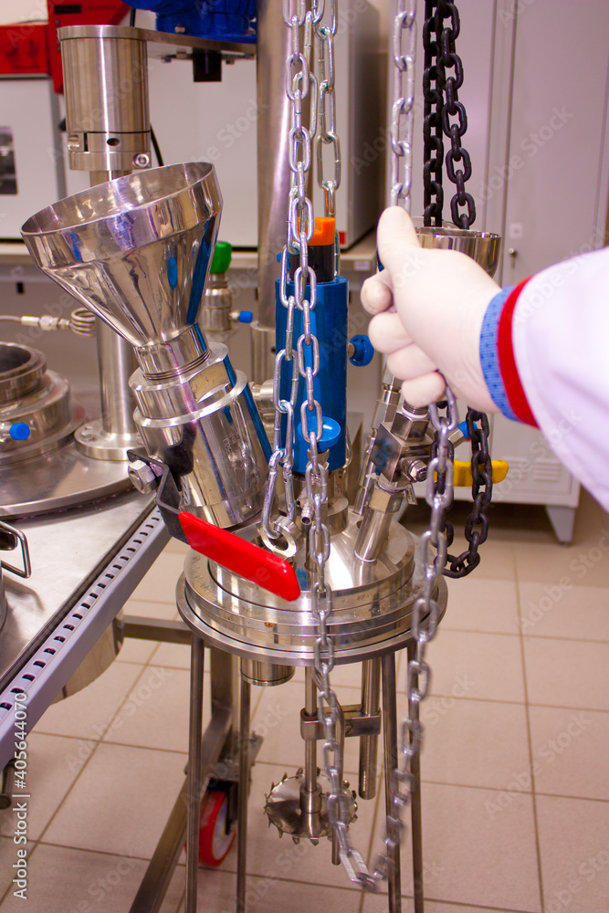 Removing the head of the pharmaceutical reactor in the laboratory ...