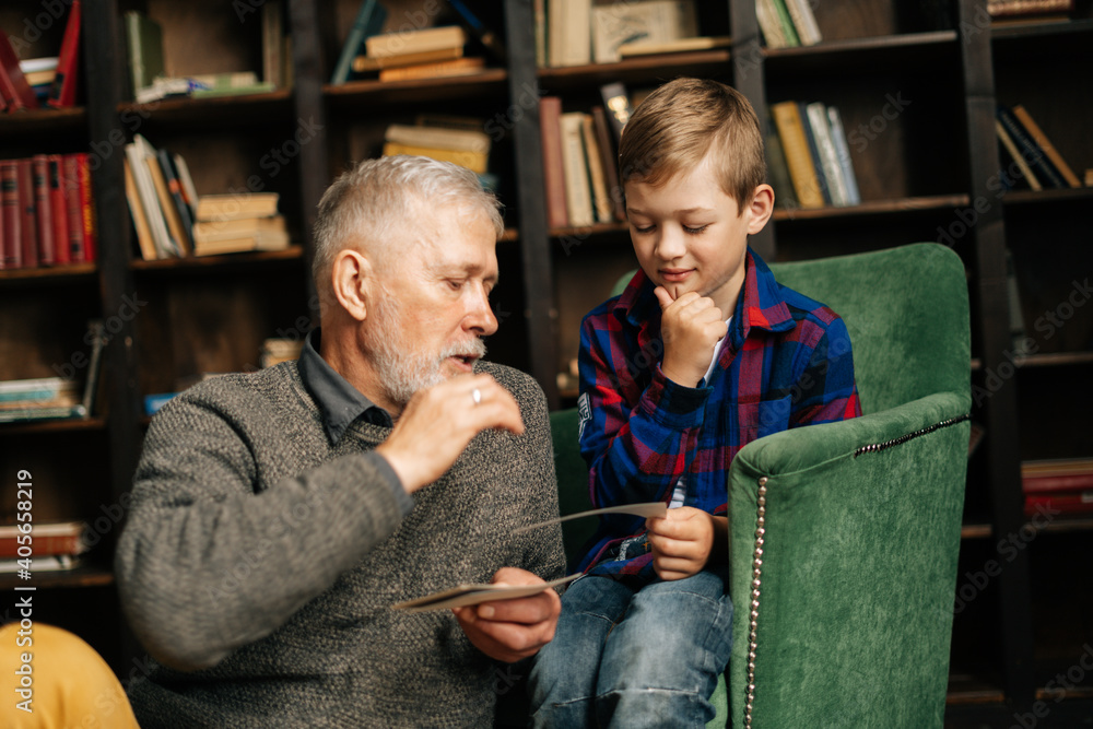 Close-up portrait of grandpa talking with little grandson, having fun ...