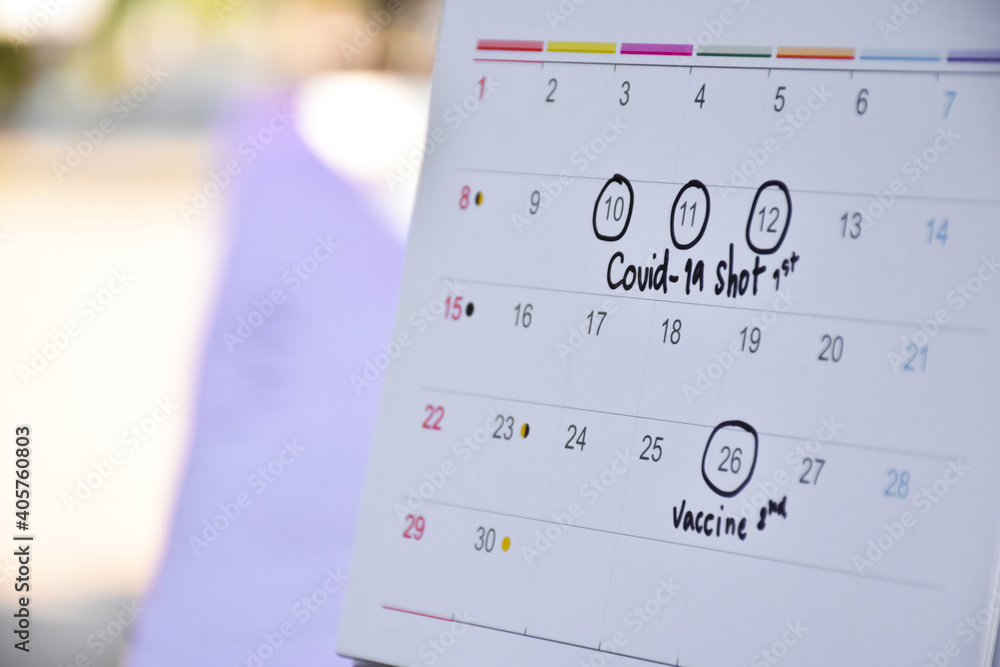 Desk white calendar with covid-19 vaccine appointment around the number ...