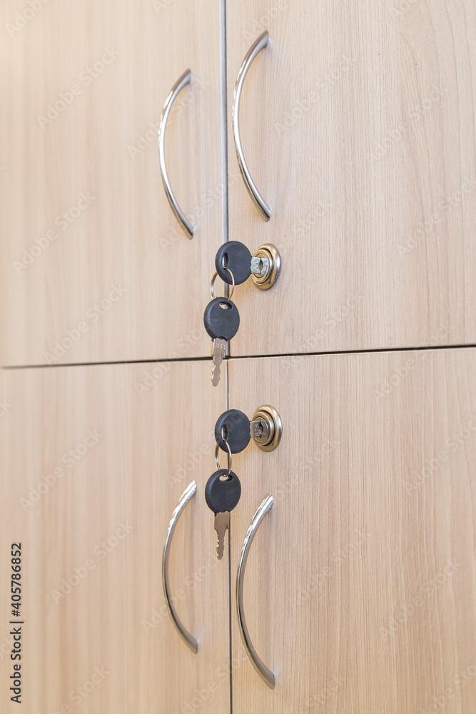 Key in office cabinet drawer lock. Keys on a row of office cabinets ...