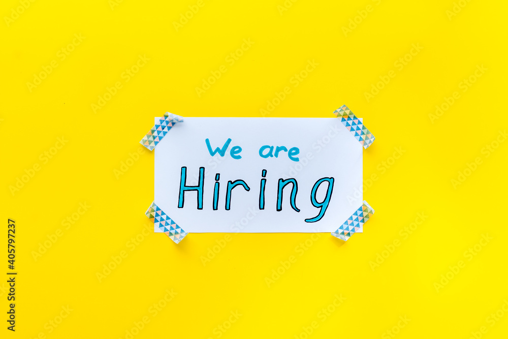 We are hiring - job recruting concept. Words We are hiring on paper ...