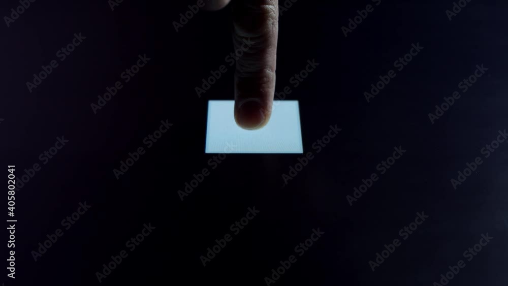 Human finger is pressing a digital button on a glowing touchscreen ...