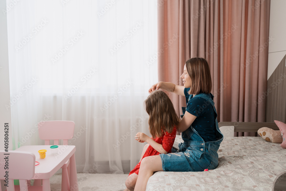 Happy delightful aunt wearing comfy jeans romper, spend time with her ...