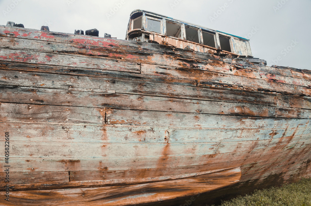 An old wooden shipwreck, showing signs of decay and deterioration. An ...
