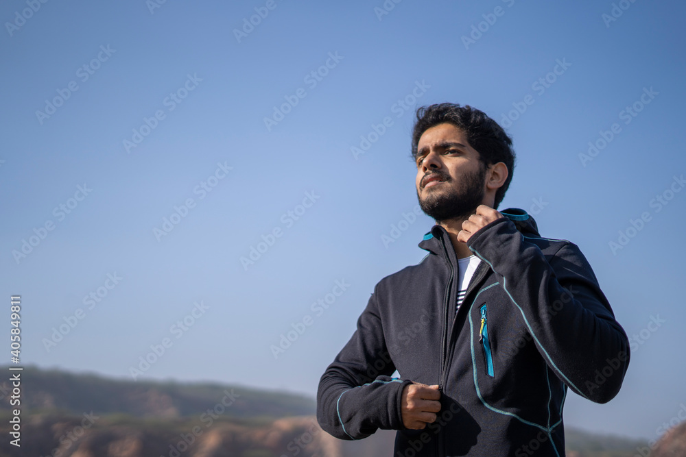 Young indian fit boy getting ready for his workout routine by wearing ...