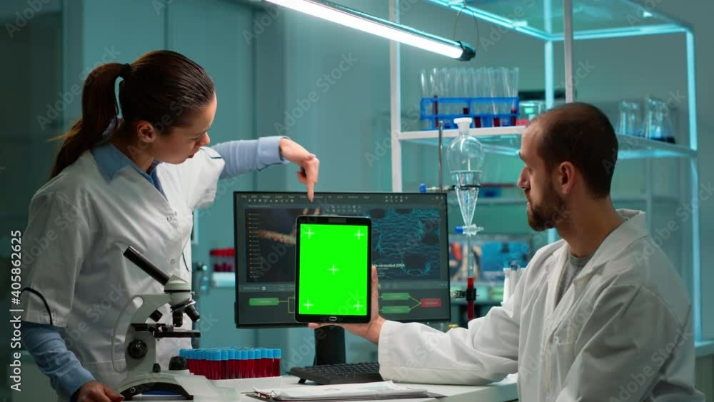 Medical research scientists using notepad with green screen mock up ...