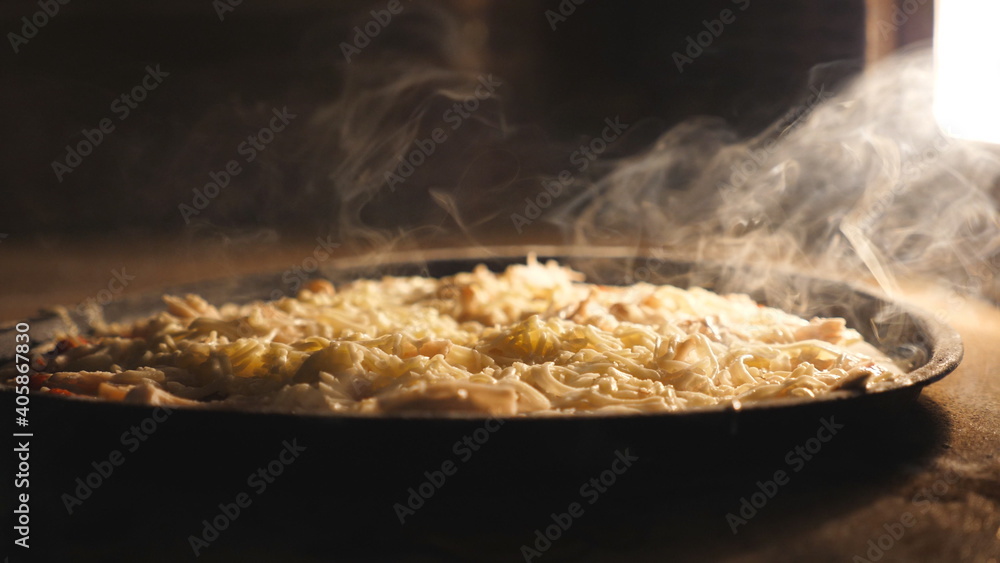 Tasty four cheese pizza is baking in electric oven at kitchen ...