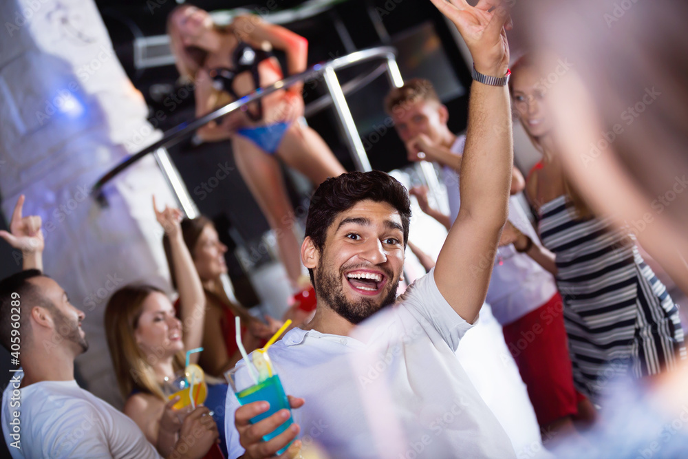 Happy smiling male joying and thumbs up on party in the club with ...