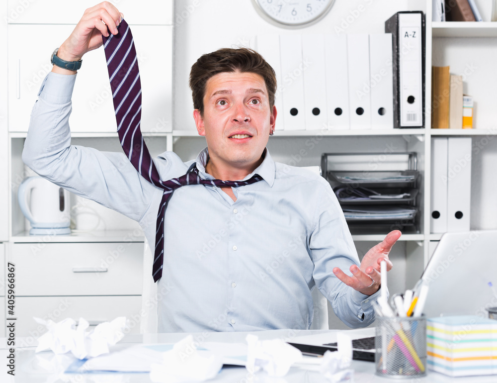 Young sad man tired of working in the modern office Stock Photo | Adobe ...