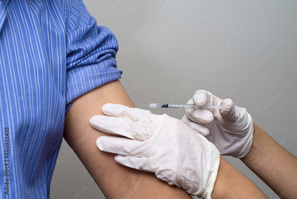 Medical worker making an injection with a standard insulin syringe ...