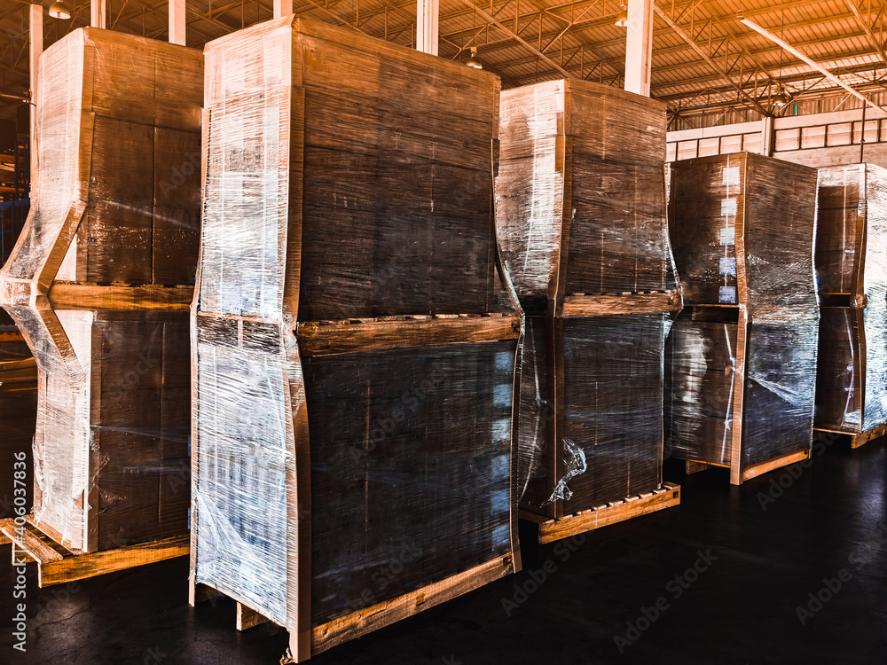 Worker driving forklift loading shipment carton boxes goods on wooden ...