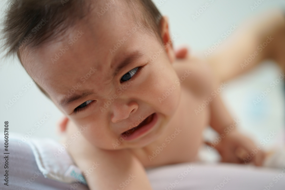 Baby asian boy crying on bed with hold by mother hand in bedroom ...