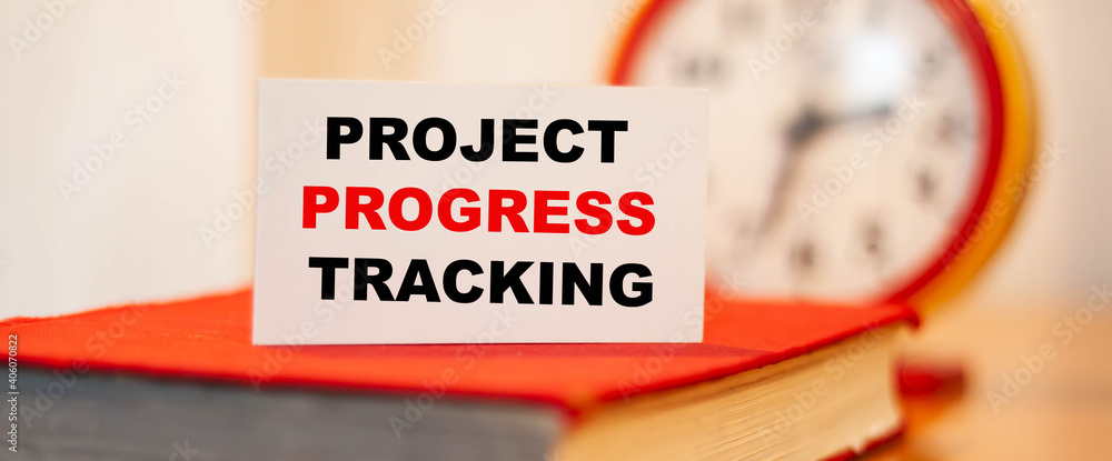 PROJECT PROGRESS TRACKING is written on a document with a time ...