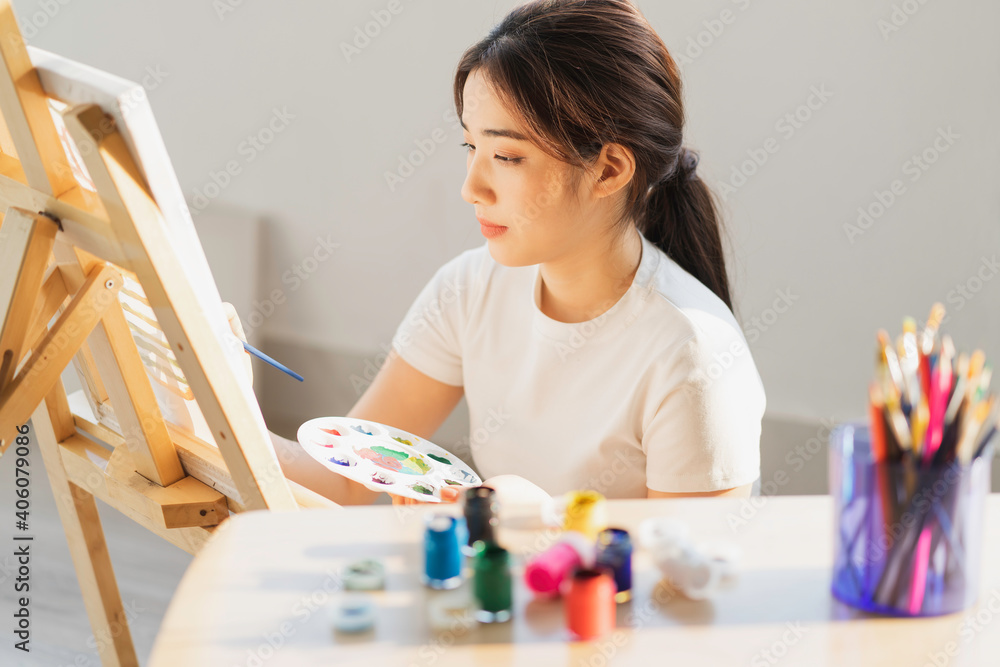 Young girl sitting on the floor learning to draw by herself Stock Photo ...