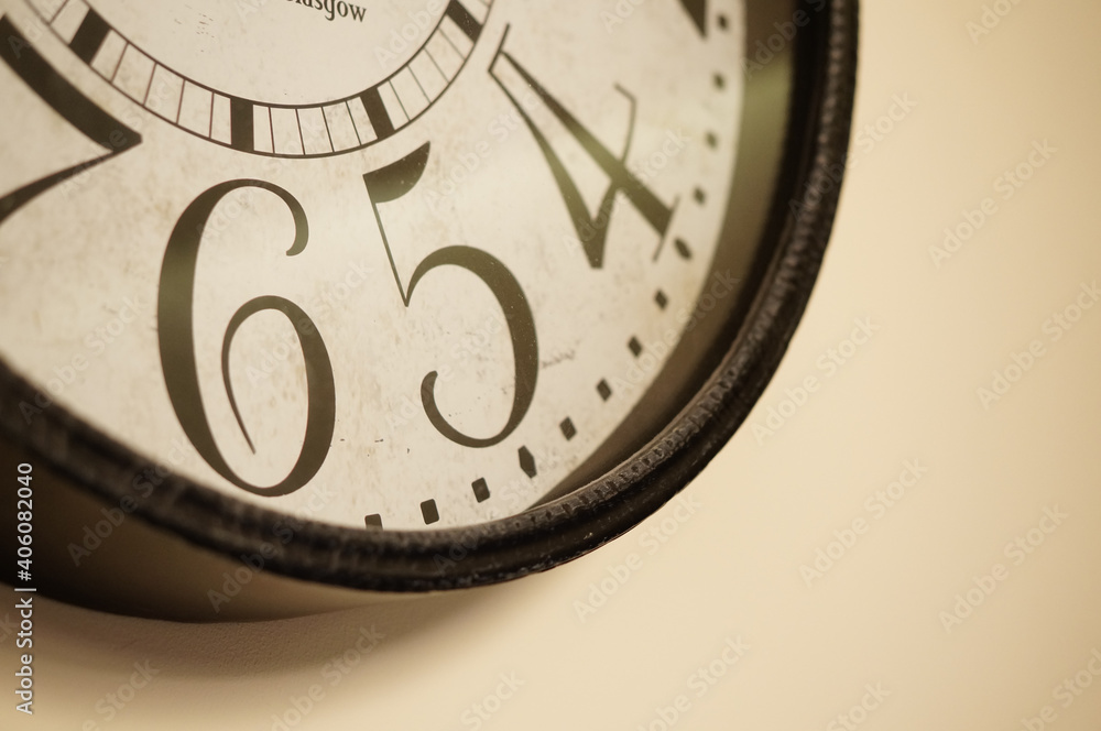 Horizontal shot of vintage clock numbers on the clock face on the beige ...