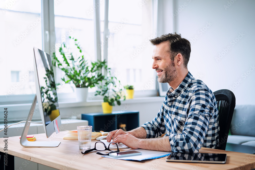 Cheerful man programmer working from home using computer Stock Photo ...