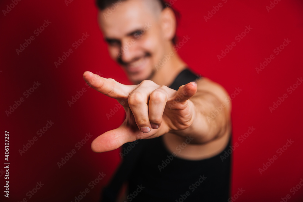 Punk with black electric guitar, mustache and big mohawk showing horn ...