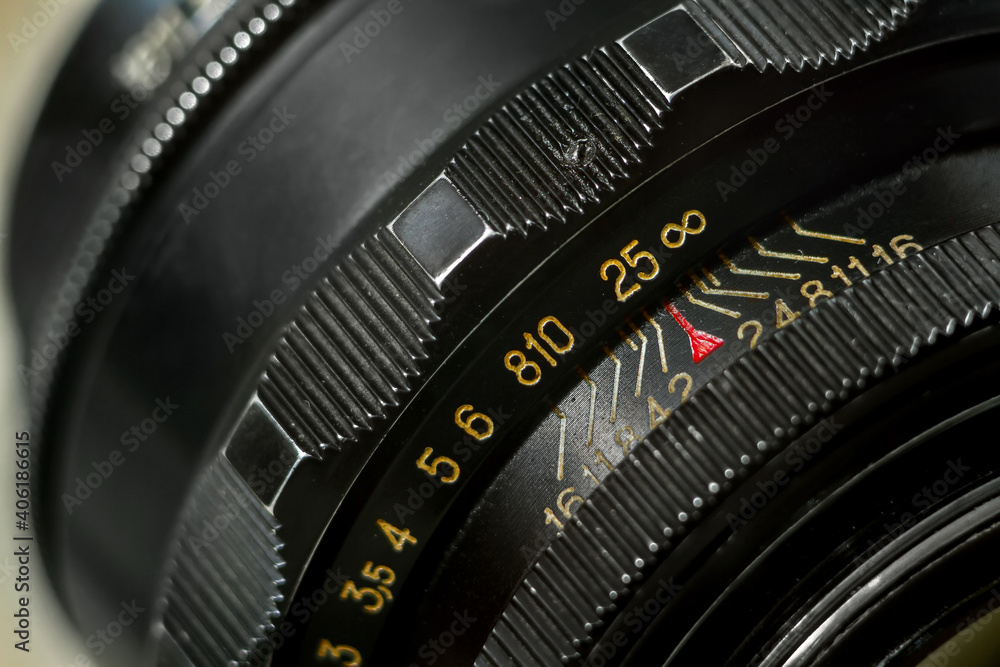 Old lens close-up. The distance scale and the scale for calculating the ...
