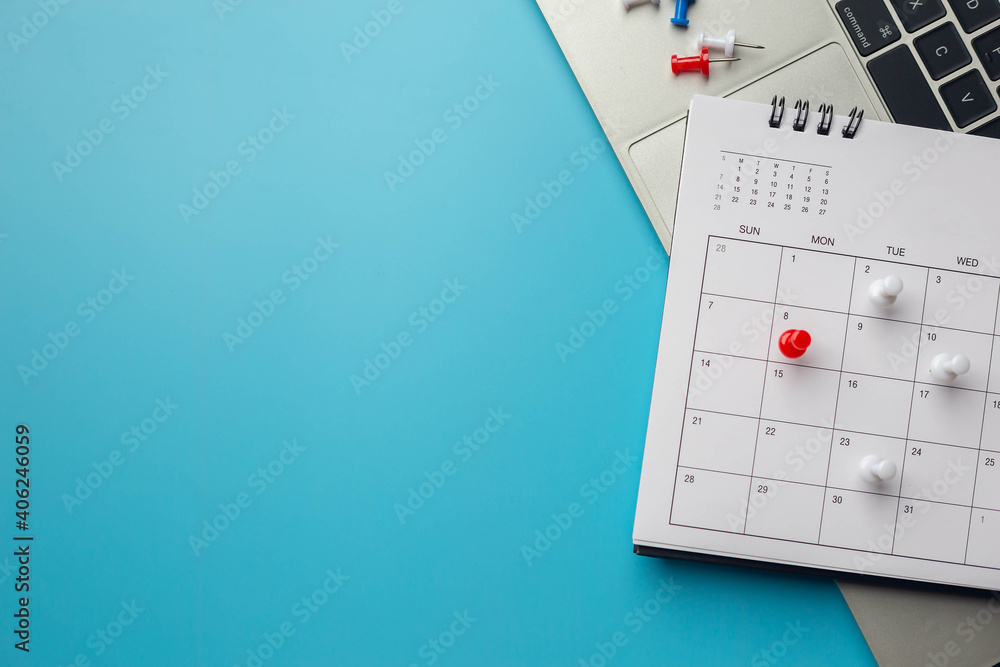 Calendar on solid ิblue background with copy space, pinned in a ...