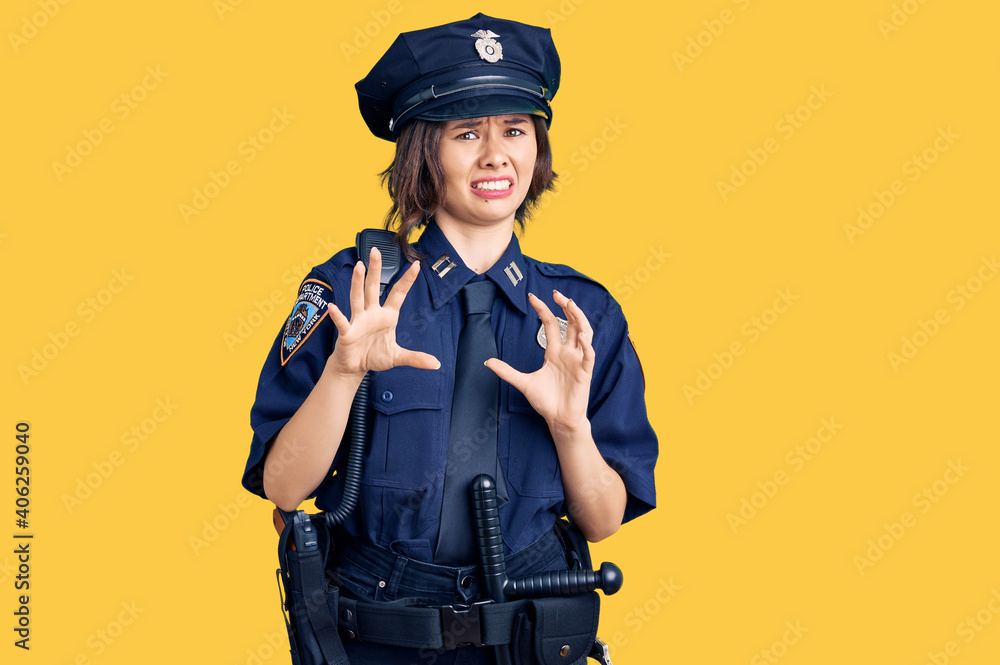 Young beautiful girl wearing police uniform disgusted expression ...