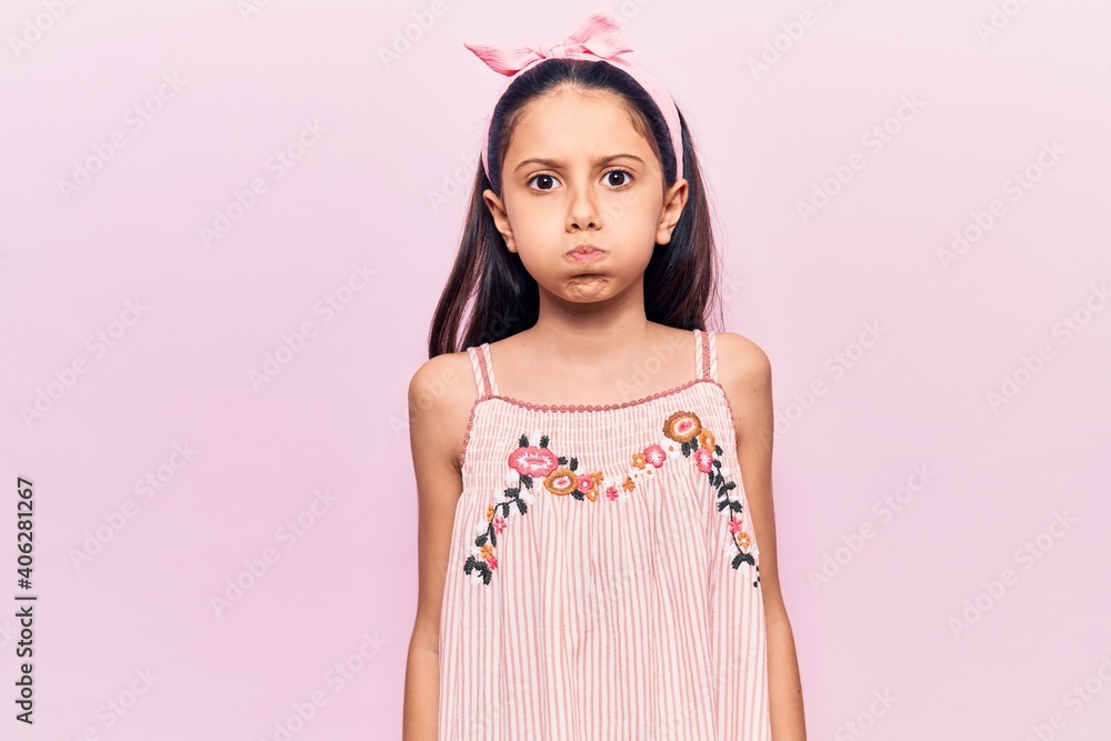 Beautiful child girl wearing casual clothes puffing cheeks with funny ...