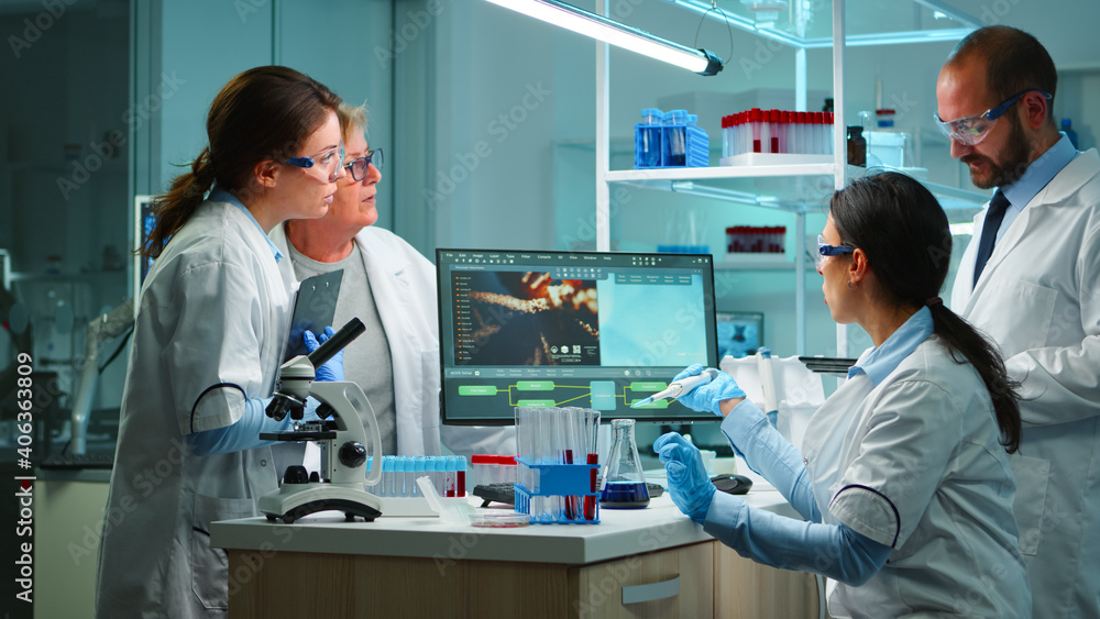 Scientist woman pipetting liquid to test tube working in equipped lab ...