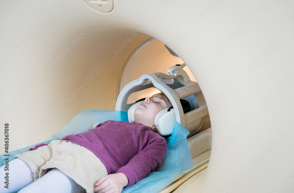 Radiologist prepares the little girl for an MRI brain examination Stock ...