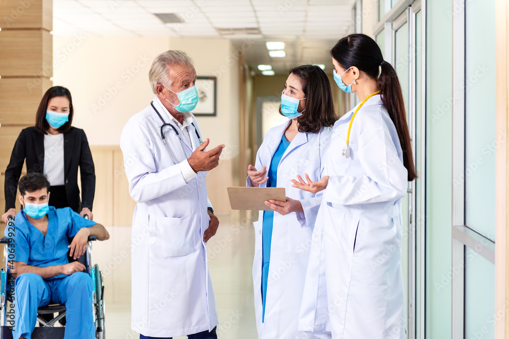 Group of medical staff discussing and report in hallway hospital ...