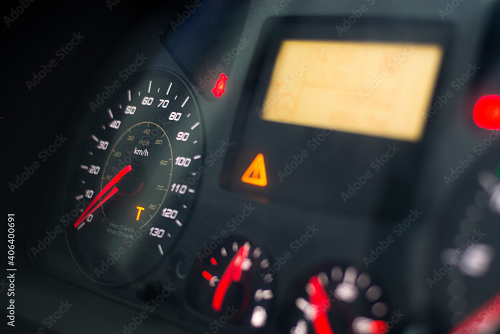 Capital T orange warning lit on speedometer of a heavy truck. Digital ...