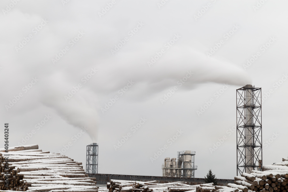 Factory with a steaming chimney and a stack of firewood. Stock Photo ...