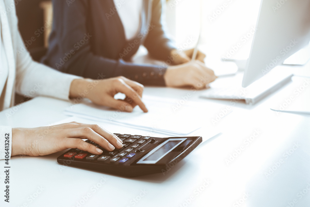 Accountant checking financial statement or counting by calculator ...