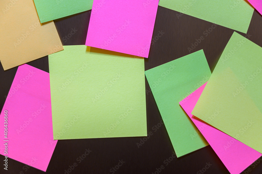 sticky sheets on dark background, notes with different color variations ...