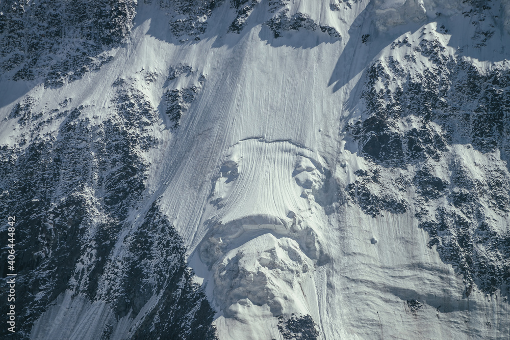 Nature background of big rocky snowy mountain wall with white glacier ...