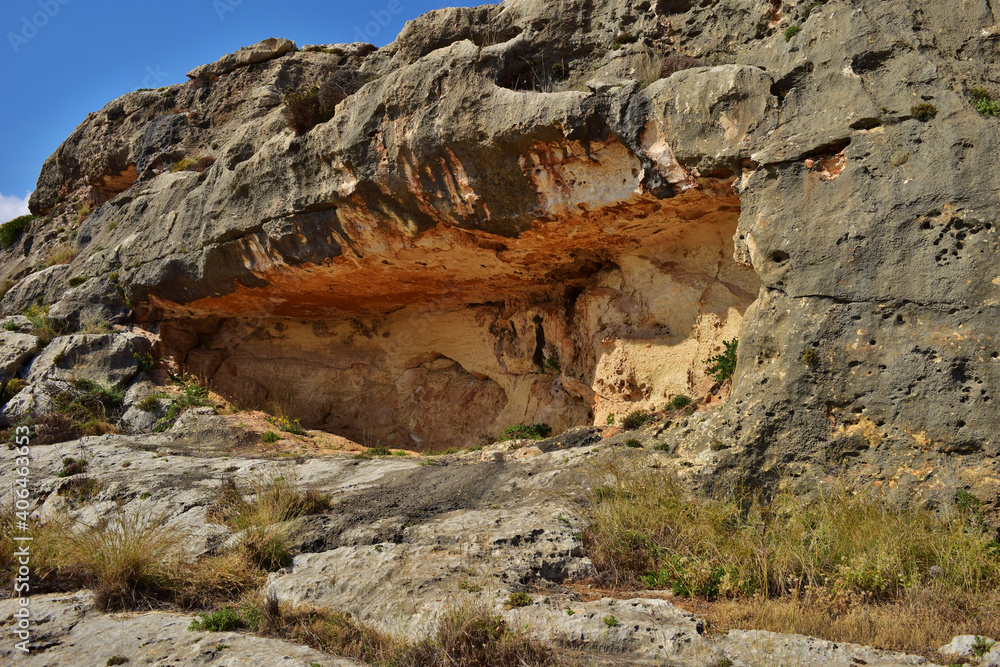 Small cave in the cliff face and karst landscape of Bassasa Valley in ...