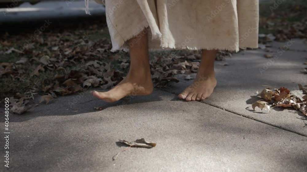 A dramatic slow motion closeup of man dressed as Jesus. It shows his ...