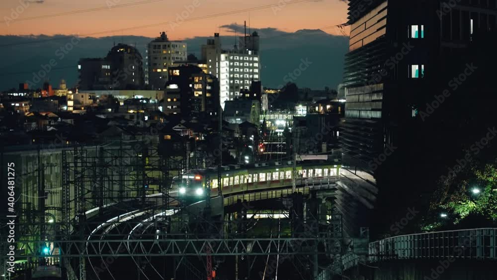 Cityscape Buildings At Tokyo With Trains Travelling On Railway At Night ...