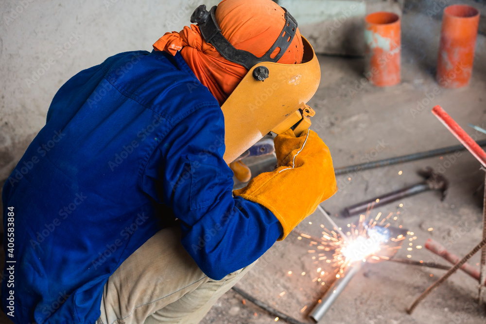 A Filipino welder or construction worker wearing protective gear ...