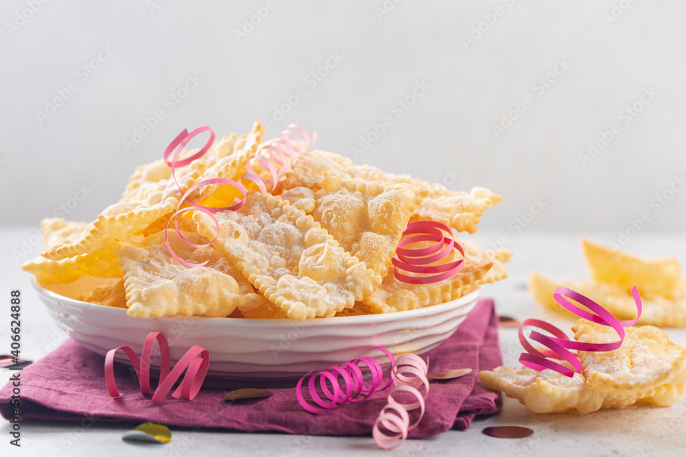 Angel wings or sfrappole or chiachiere. Traditional sweet crisp pastry ...