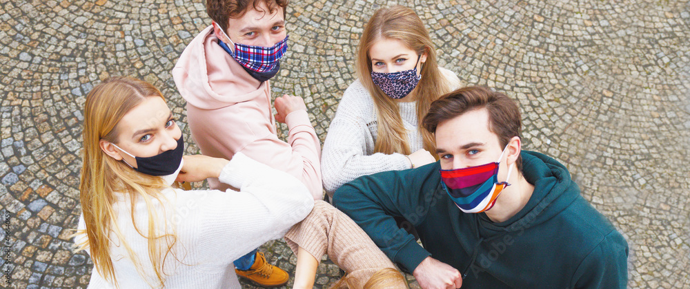 Multiracial friends teamwork elbow bump - Friends wearing mask and ...