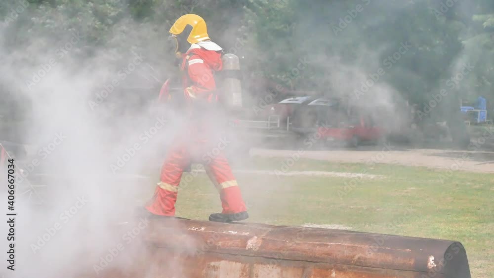 Firefighter fighting with fire flame protection property. Fireman wear ...
