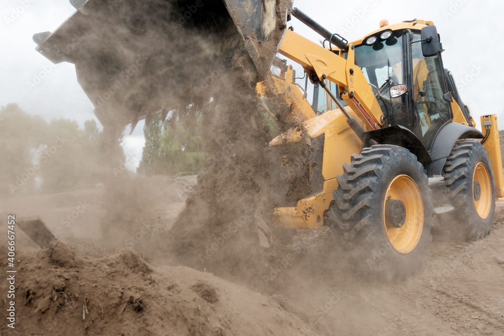 Wheel loader Excavator unloading sand soil during construction ...