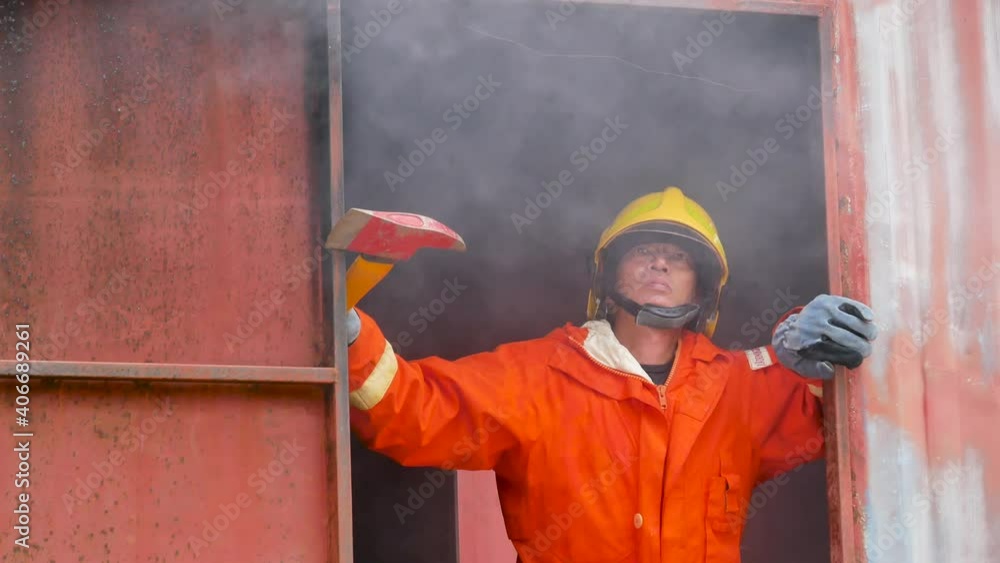 Firefighter fighting with fire flame protection property. Fireman wear ...