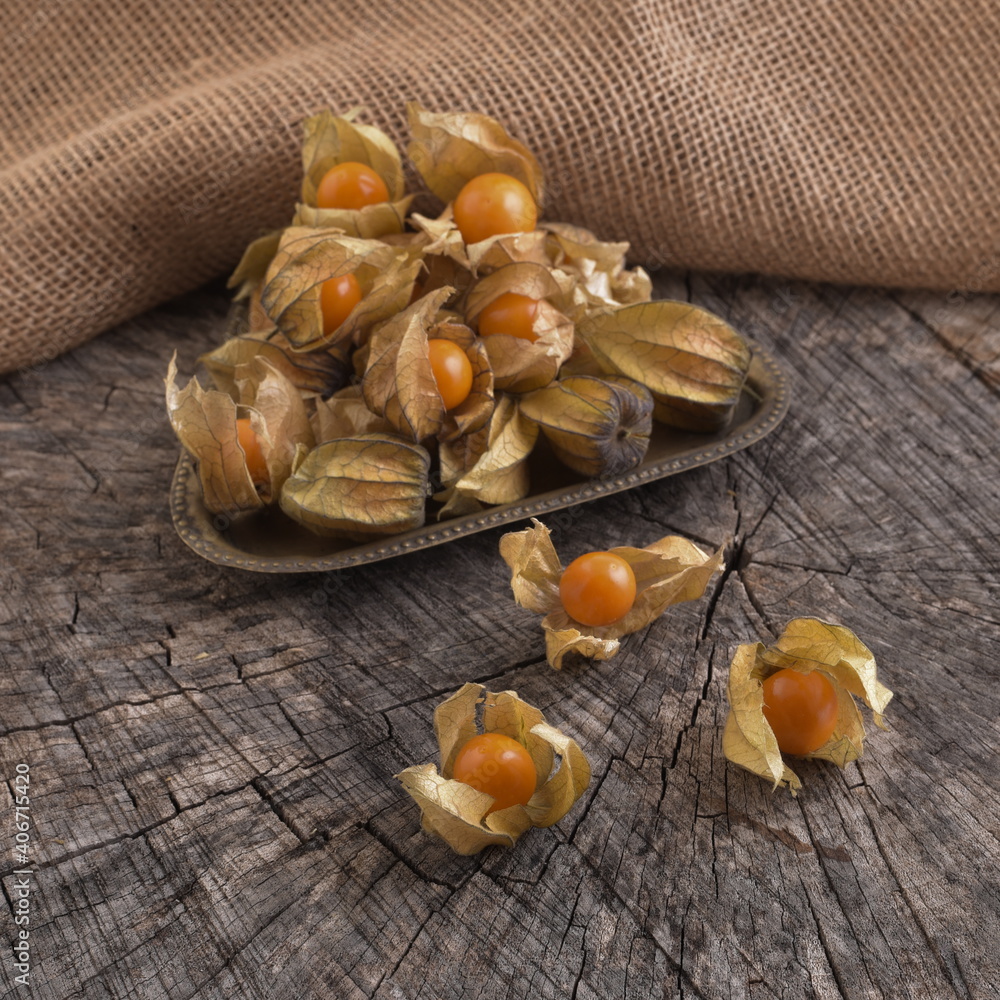 Physalis peruviana. Edible golden berries of physalis on old wooden ...