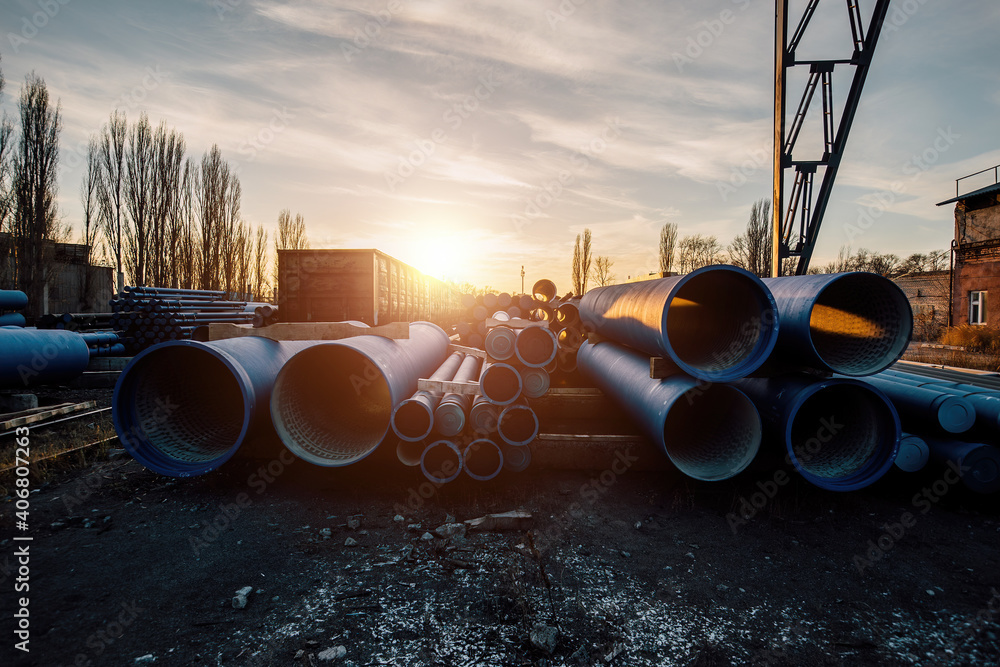 Stack of cast iron pipes in loading area waiting for transportation ...
