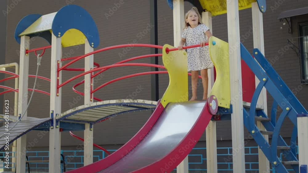 Little Girl On The Playground. Girl Runs Out On The Slide And Gets Off ...